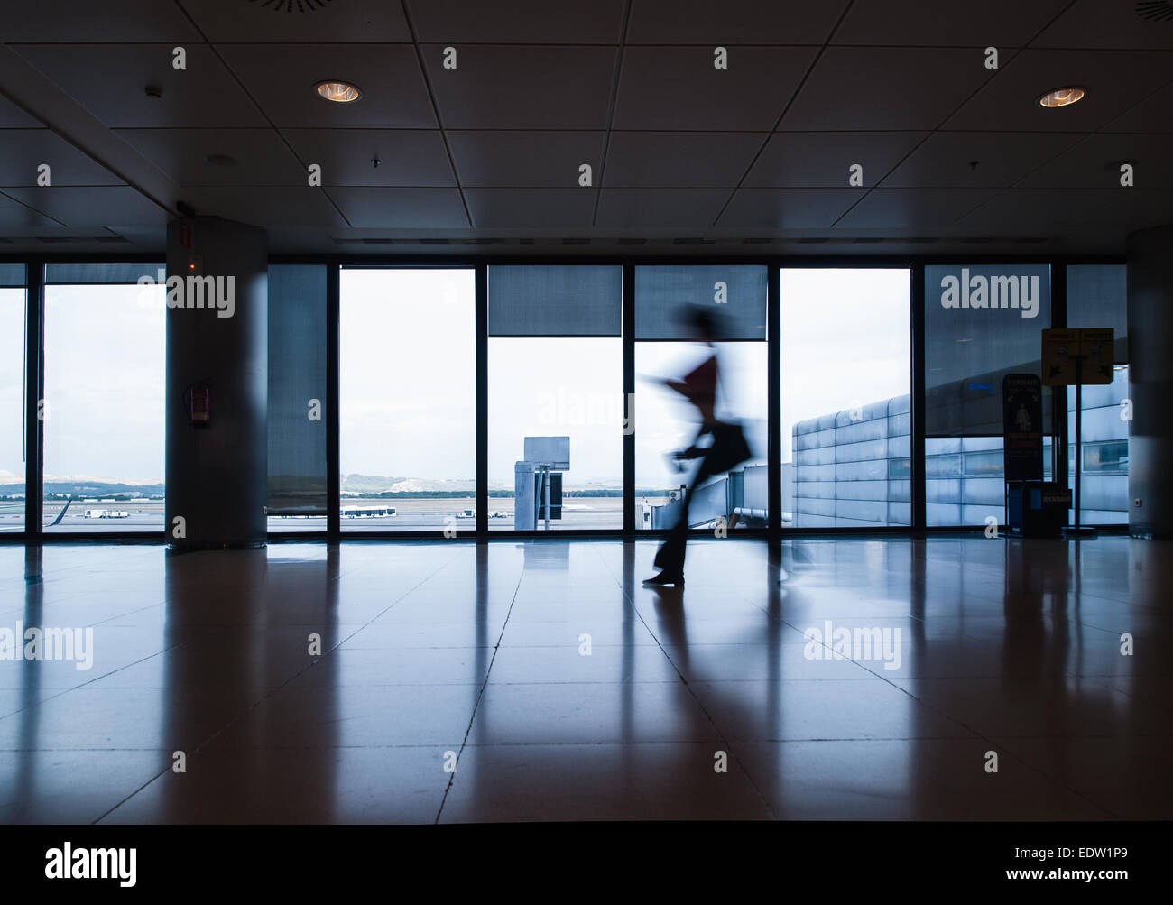 Person in motion in an airport in horizontal composition Stock Photo ...