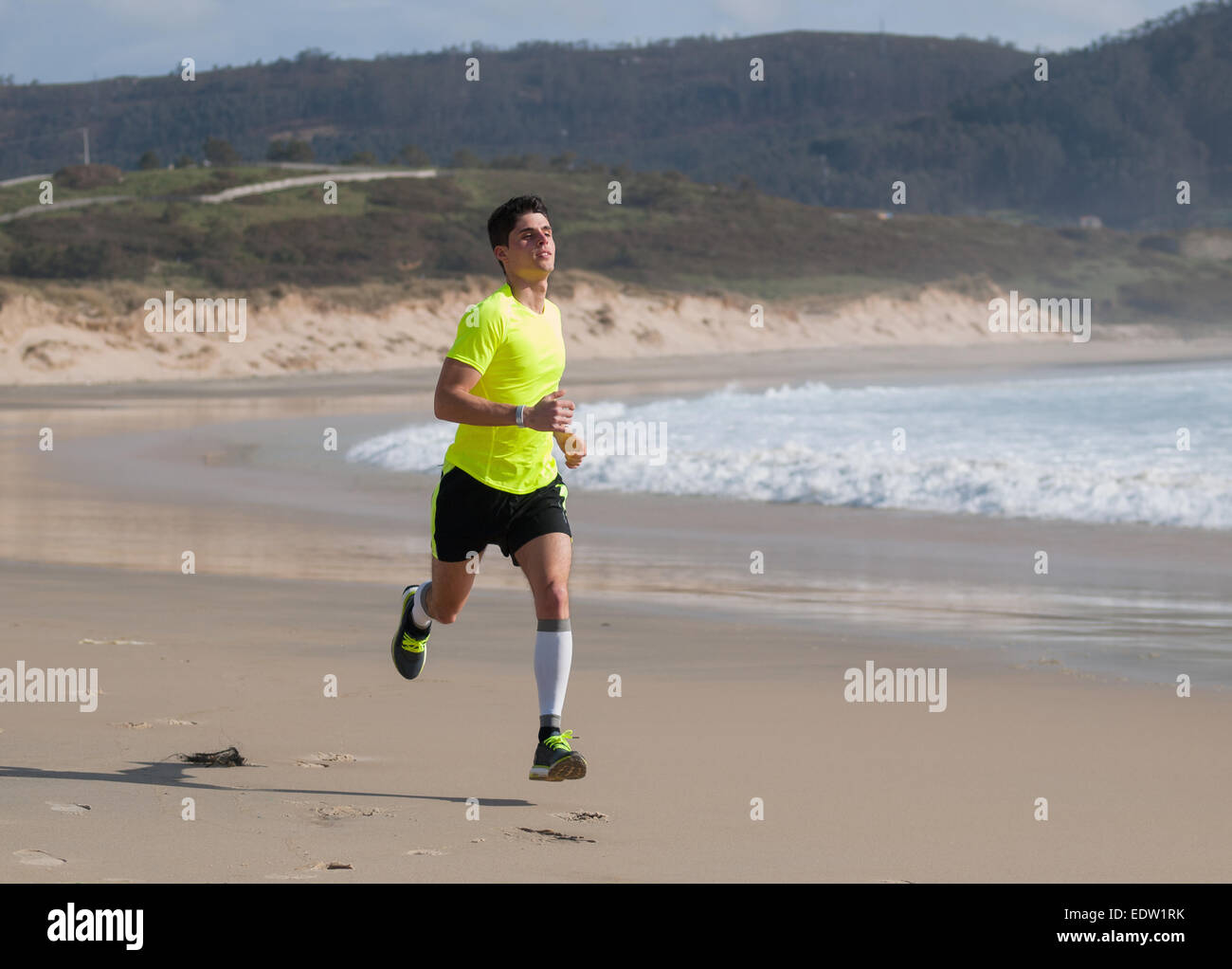 Man running along the beach hi-res stock photography and images - Alamy