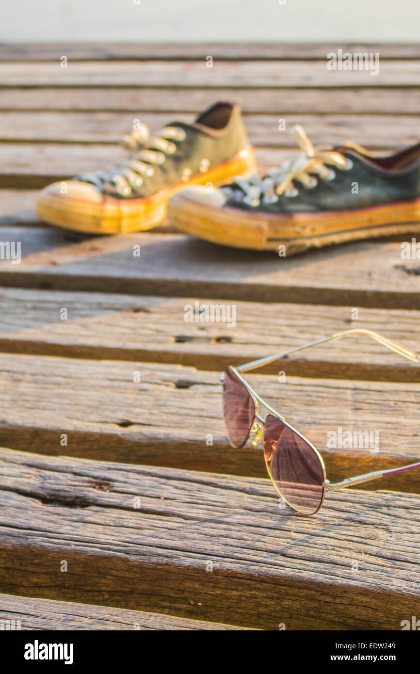 Glasses and shoes on wooden floor Stock Photo - Alamy