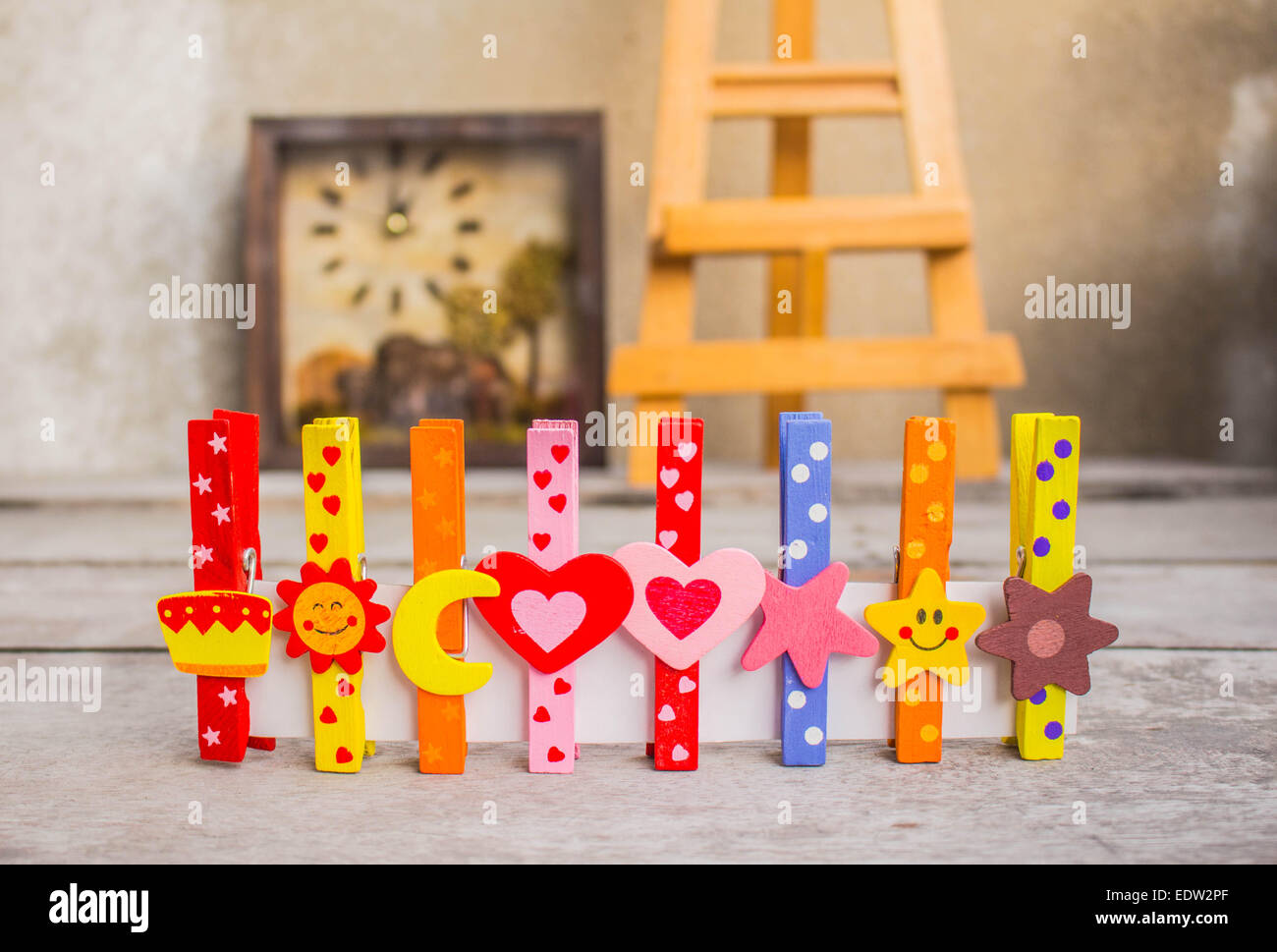 Colorful peg in a row on the wooden Stock Photo - Alamy
