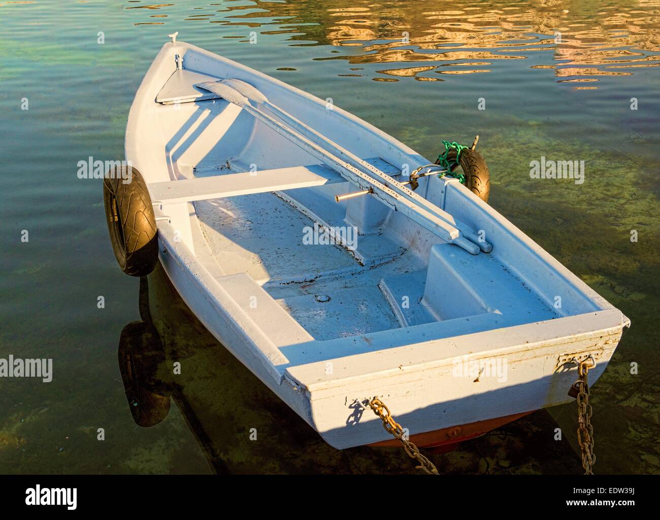 small rowing boat with two old tires Stock Photo - Alamy