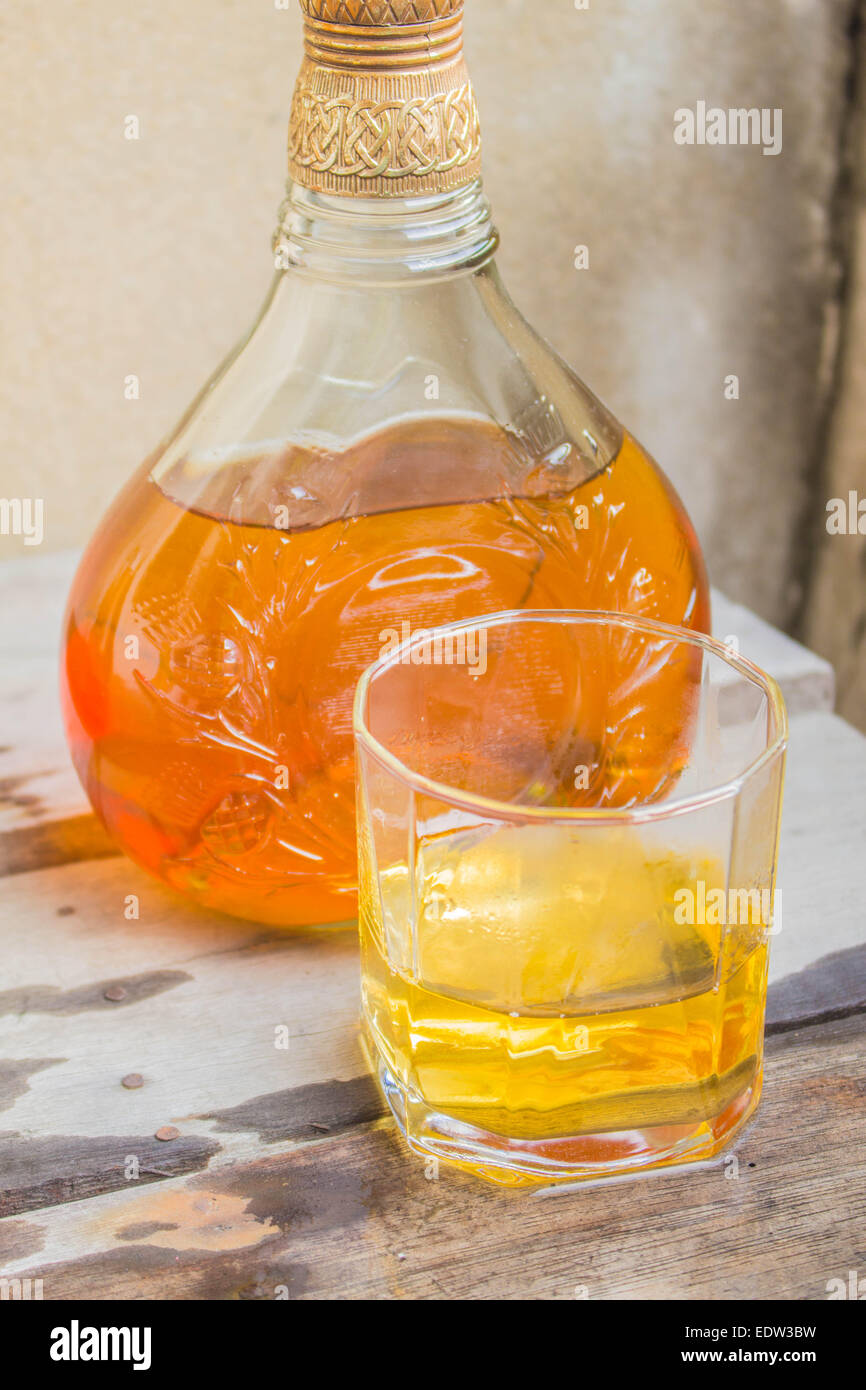 Glass of whiskey spilled on the wooden floor Stock Photo - Alamy