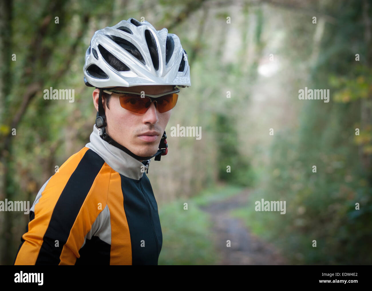 Cyclist portrait in a path of the forest Stock Photo - Alamy
