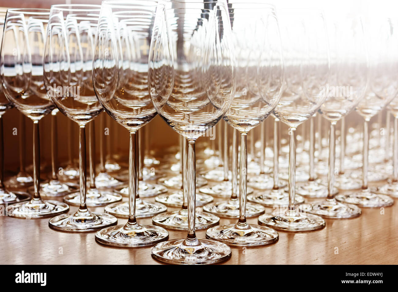 Rows of shiny empty high glasses with reflections in restaurant ...