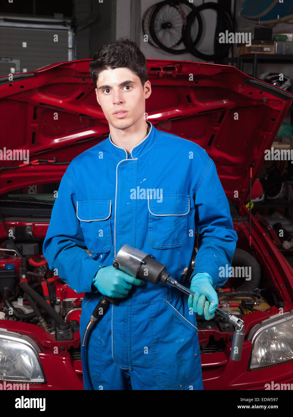 Mechanical holding a tool in a garage Stock Photo - Alamy