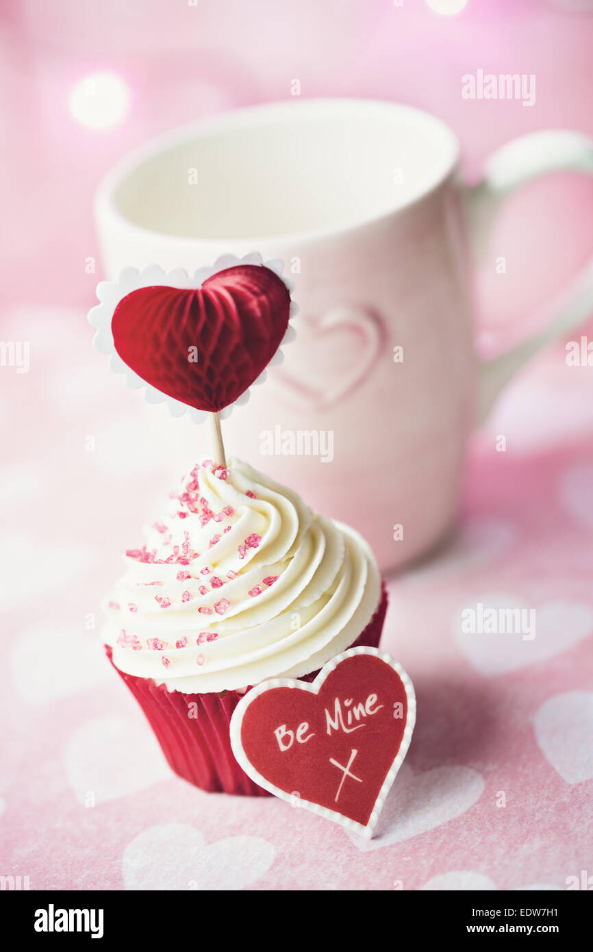 Cupcake decorated with a heart shaped cake pick Stock Photo - Alamy