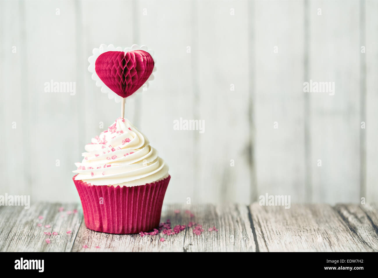 Cupcake decorated with a heart shaped cake pick Stock Photo - Alamy