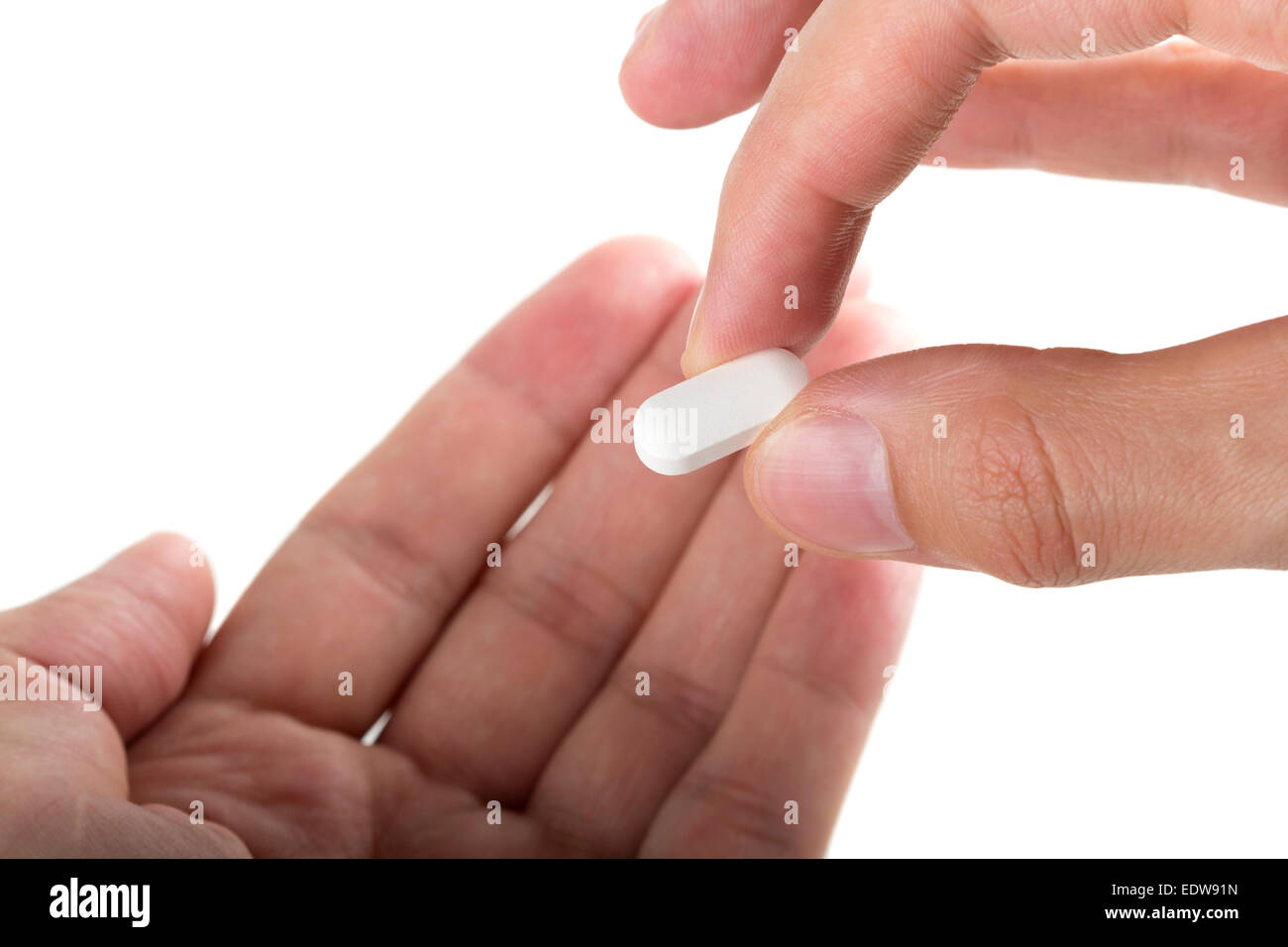 Man hand giving a pill to the patient isolated over white background ...