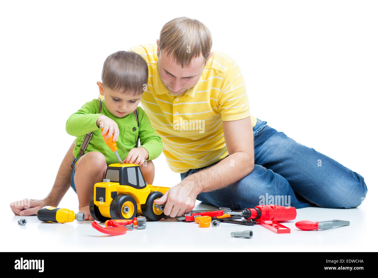 kid and his dad repair toy tractor Stock Photo - Alamy