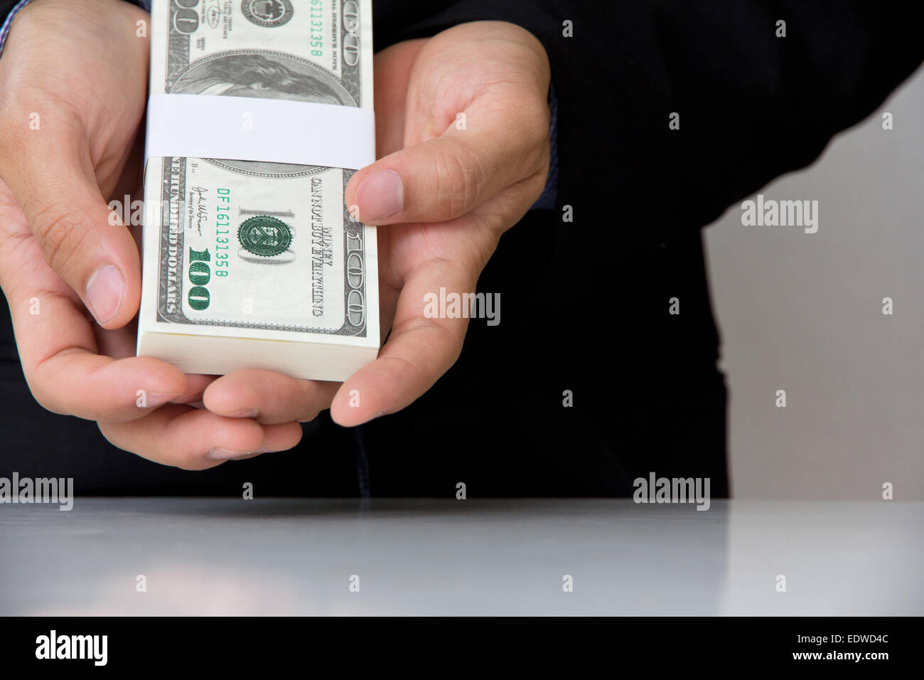 Hand giving money Stock Photo - Alamy