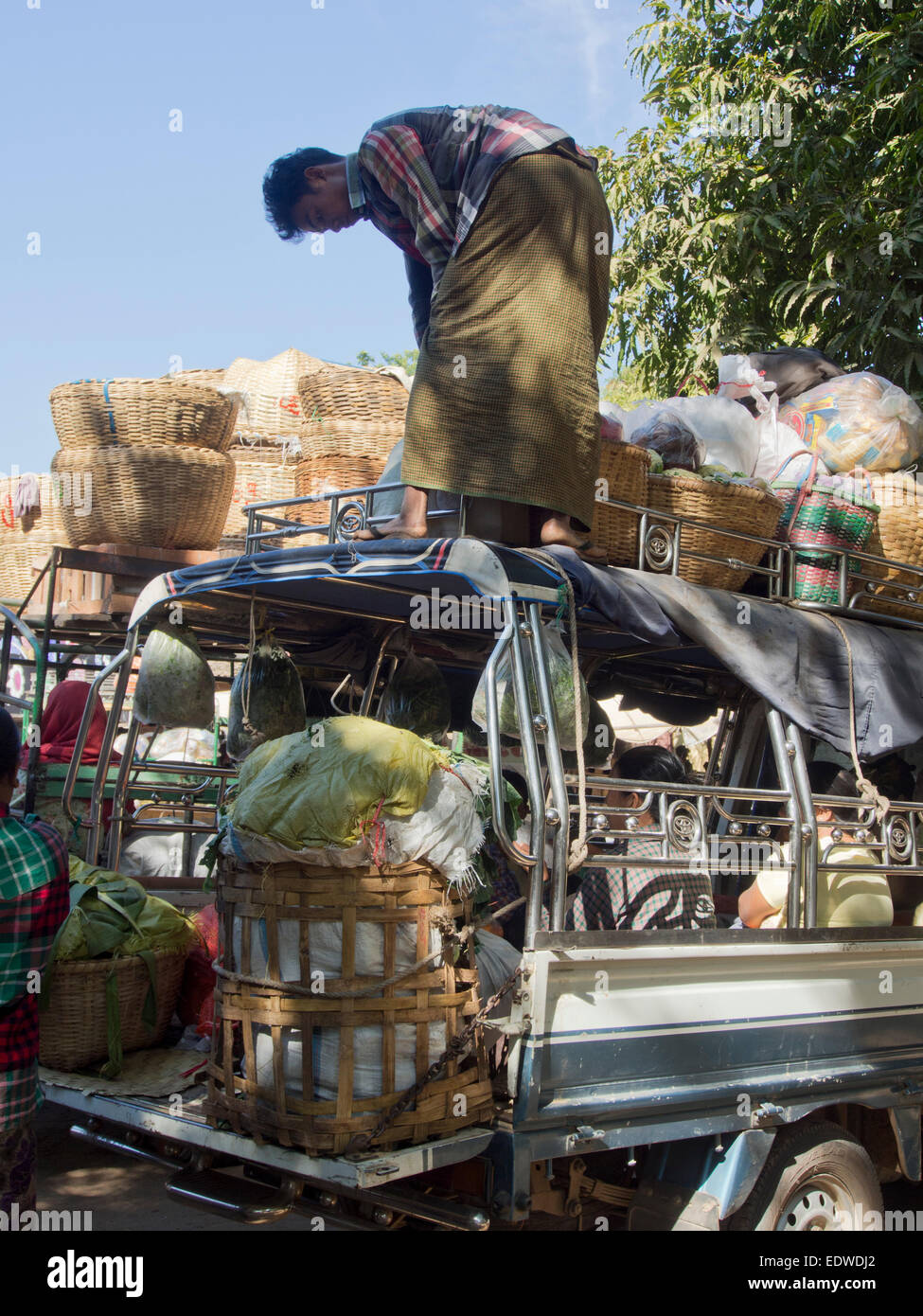 Van being loaded with goods at a market place in a village in Myanmar ...