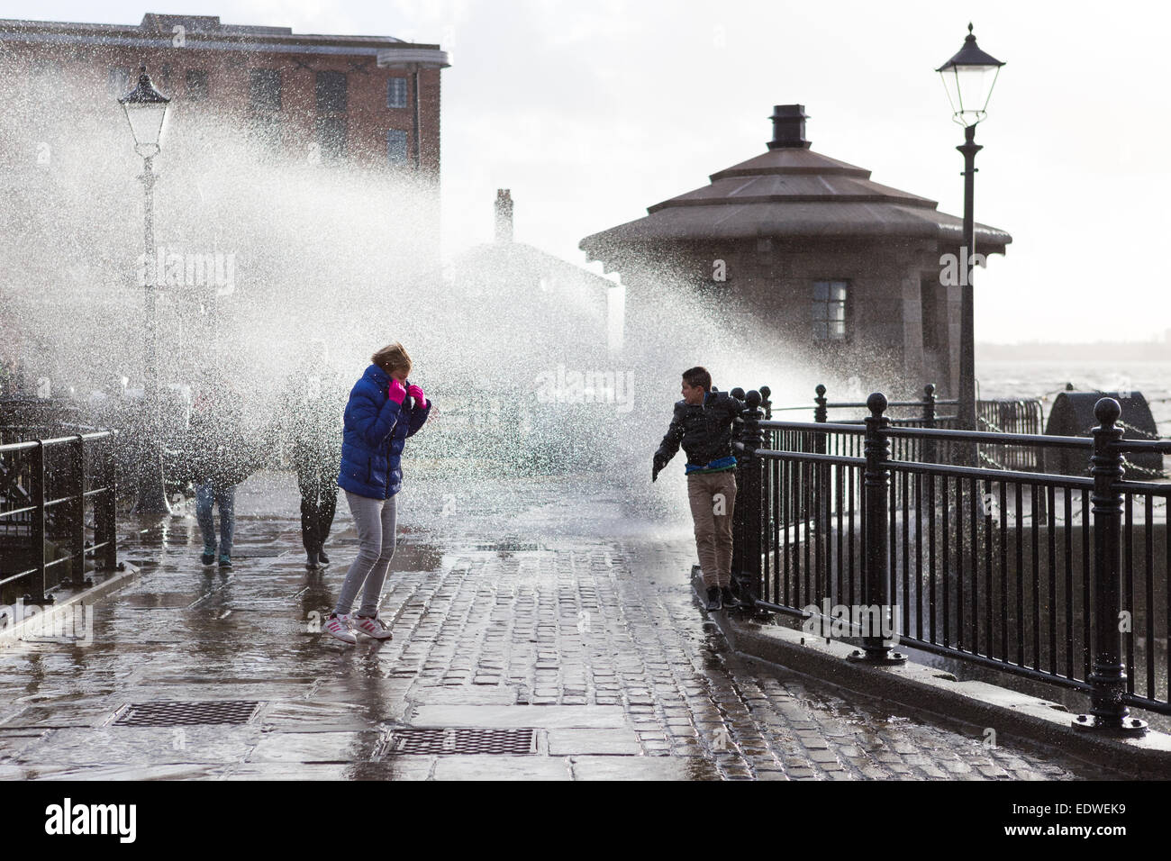 Liverpool, UK. 10th January, 2015. Two people are soaked by spray from ...