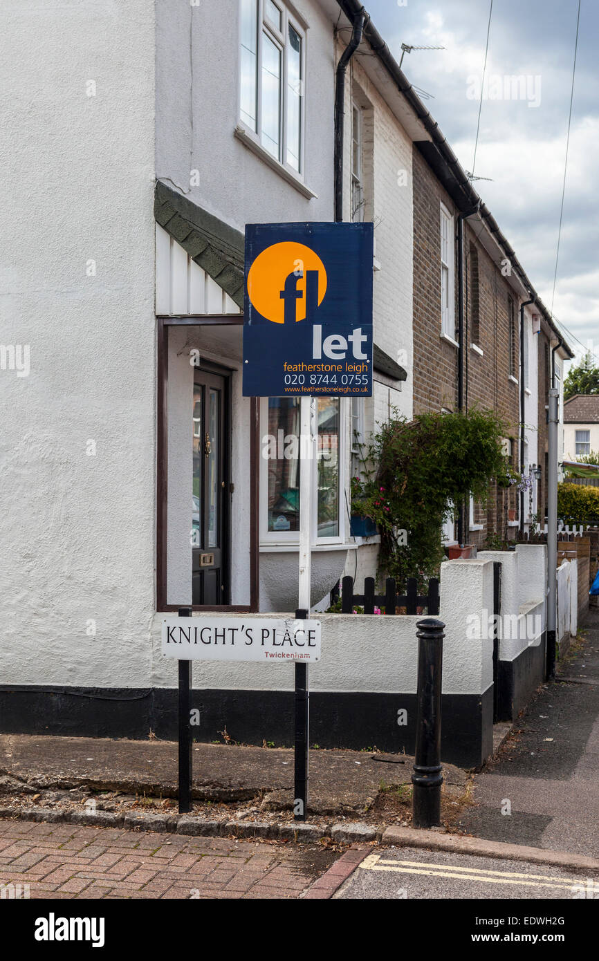 House to let, estate agent's sign outside typical English cottages ...