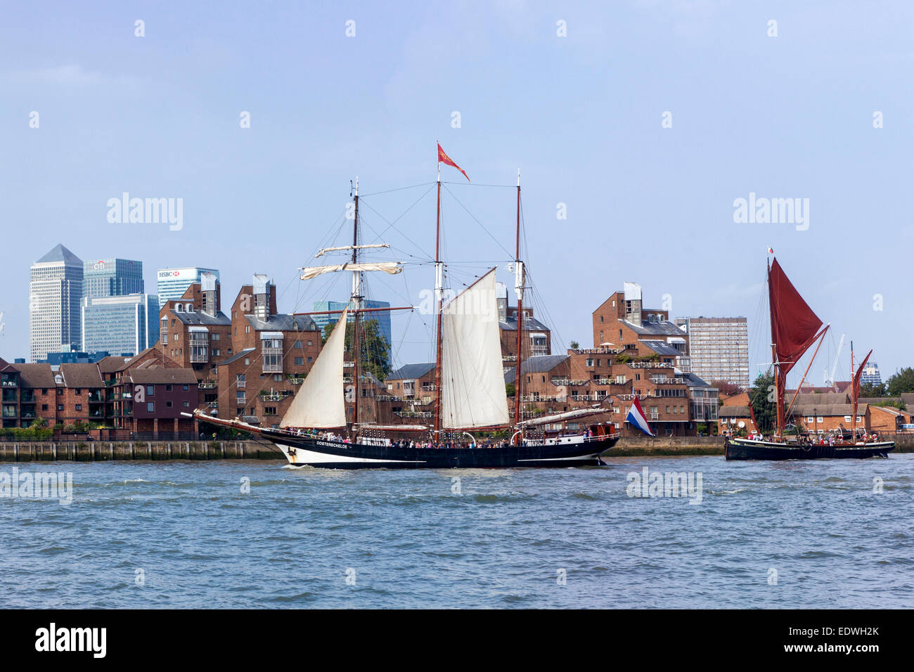 Tall ships with sails sailing up the river Thames near Canary Wharf ...