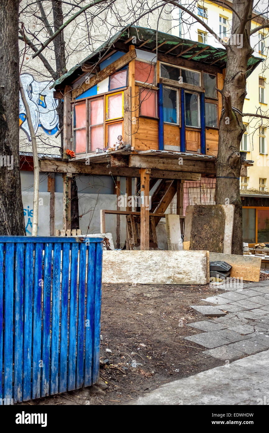 Quirky tree house built on stilts from reclaimed materials in an urban ...