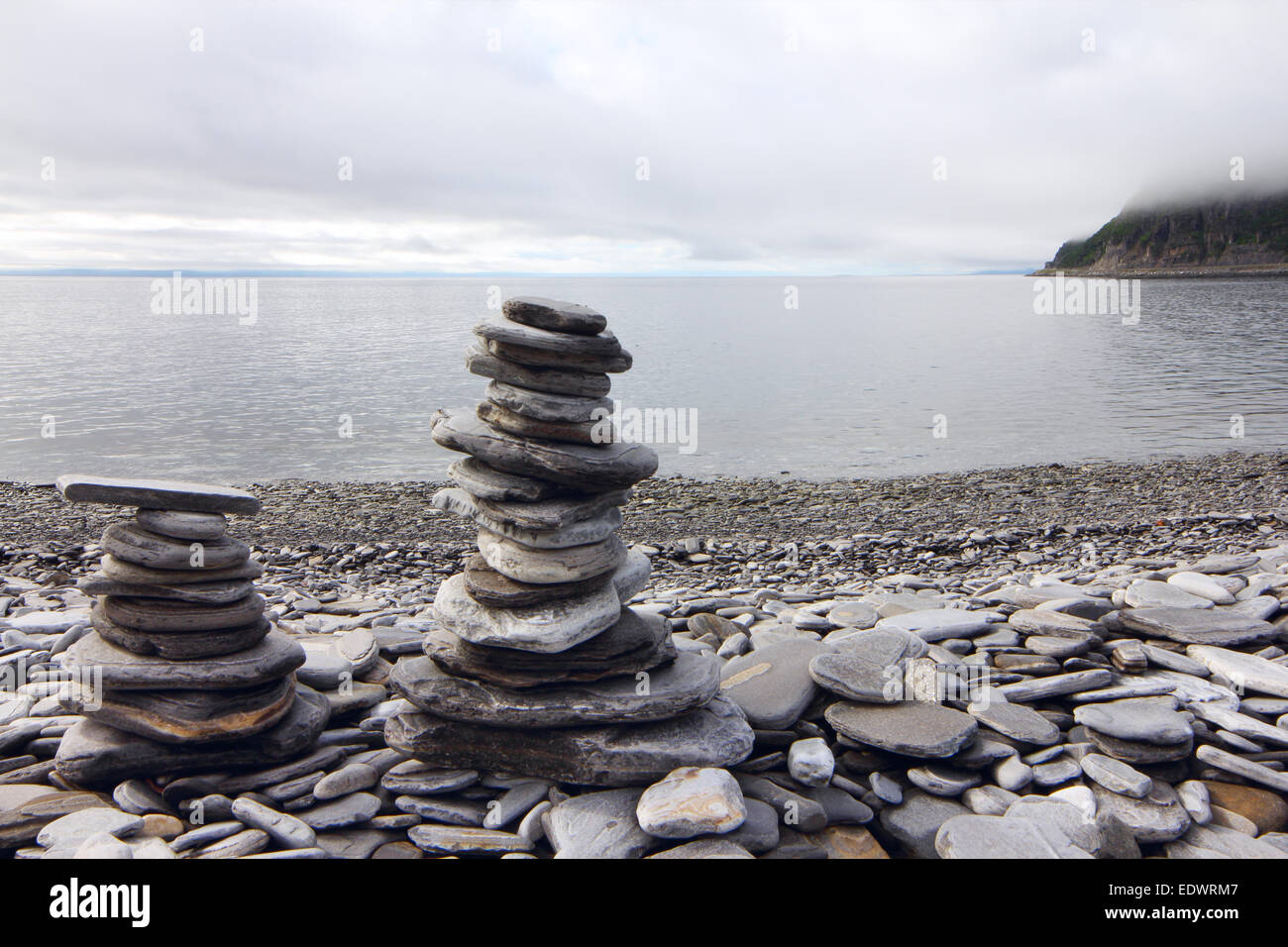 Stack of stones on northern Norway fjord background Stock Photo - Alamy