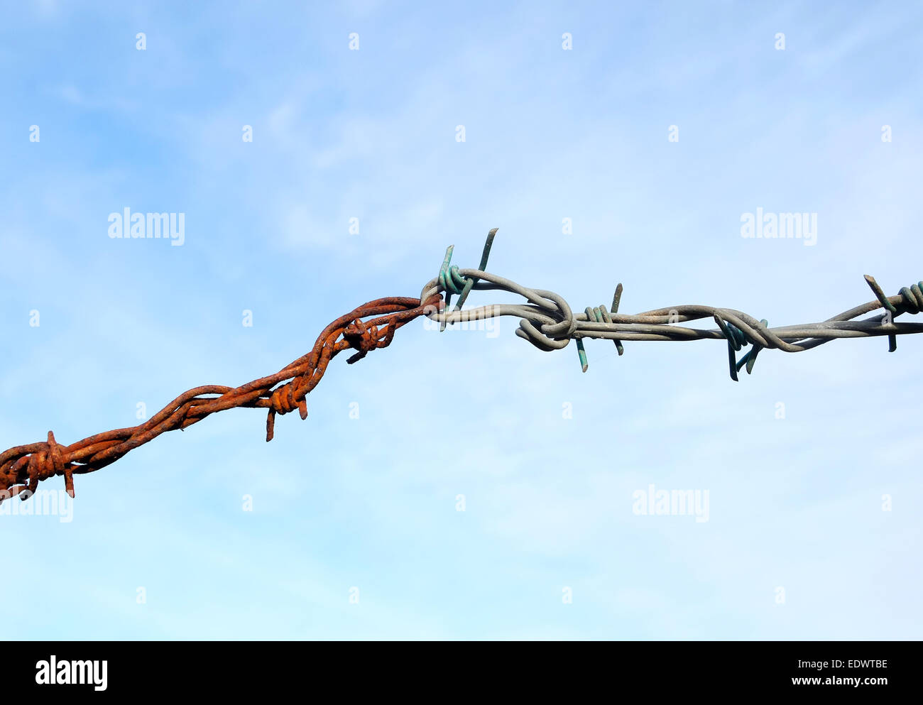 Symbolic old and new barbed wire to show the continuation of a war or ...