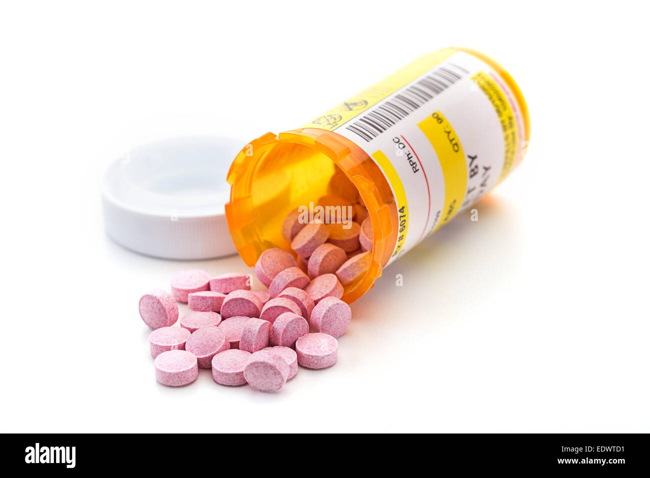 Prescription medication cascading out of orange pharmacy vials isolated ...