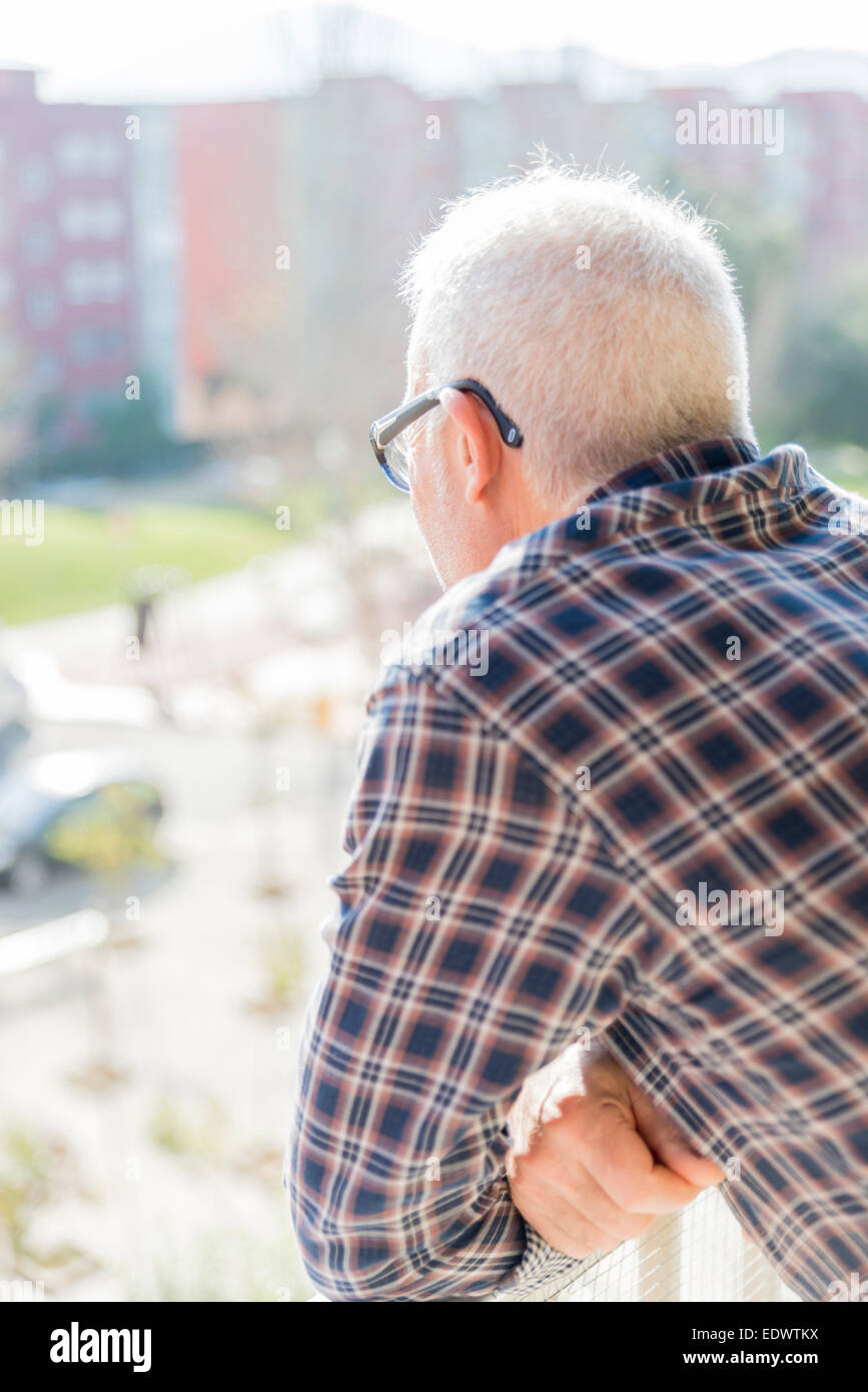 adult man looking out the balcony to the horizon Stock Photo - Alamy