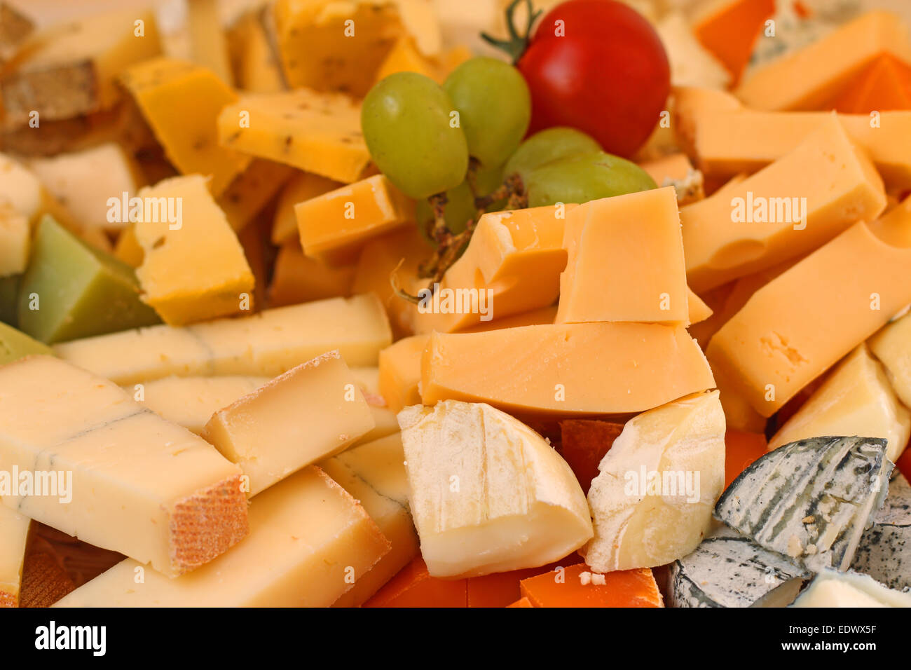 Cut french cheese blocks background close-up Stock Photo - Alamy
