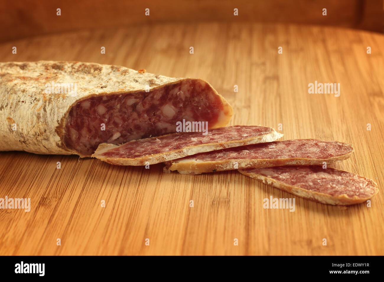 Sliced dried french sausages on wooden table Stock Photo - Alamy