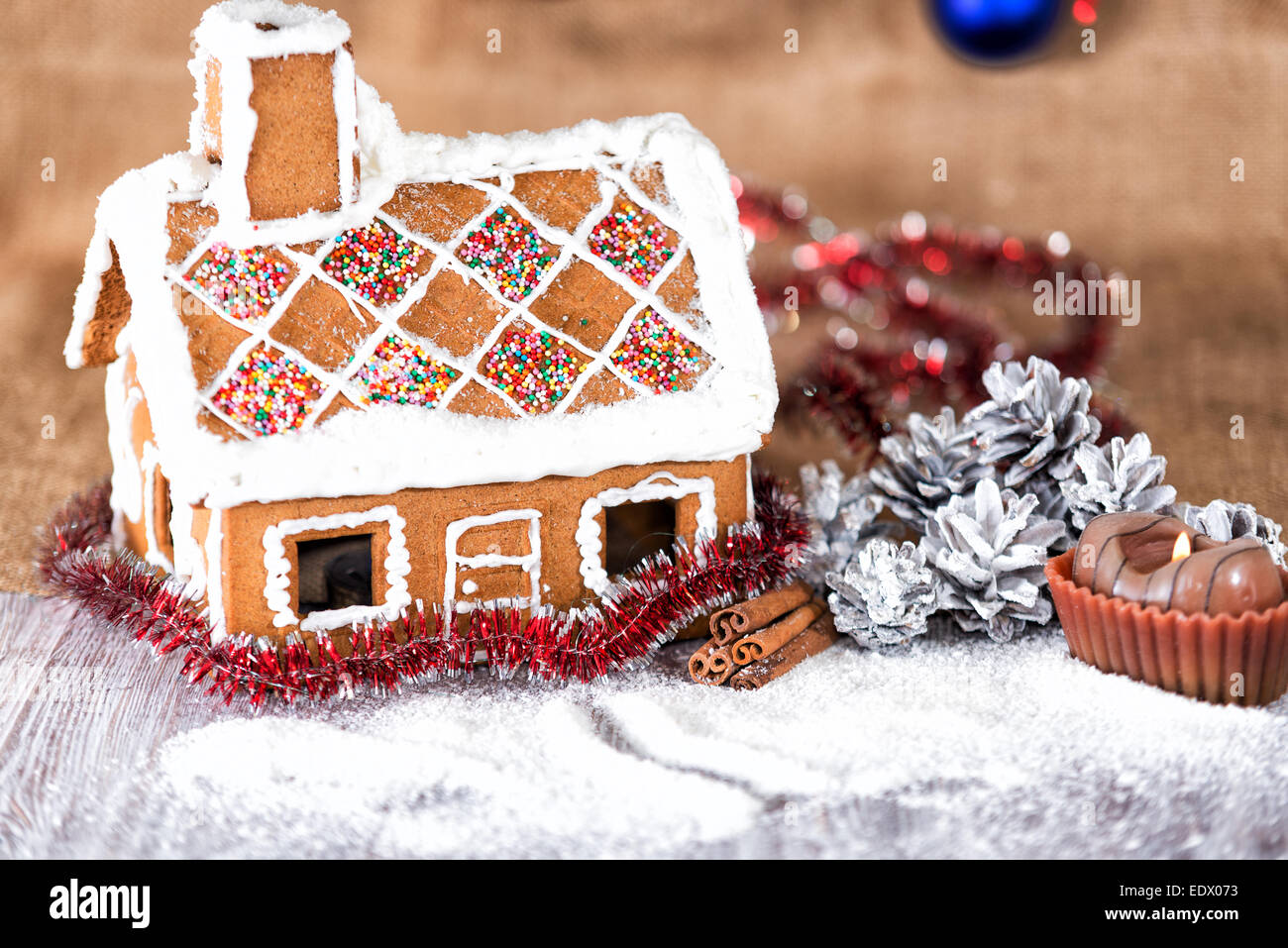 traditional gingerbread house on a background of Christmas decorations ...