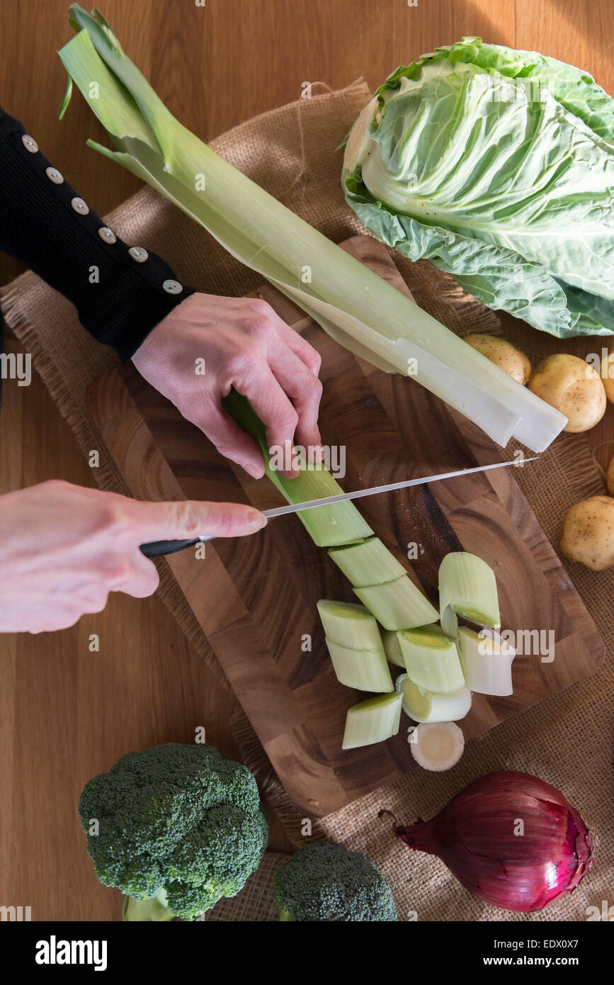 A womans hands slicing vegetables for a recipe Stock Photo - Alamy