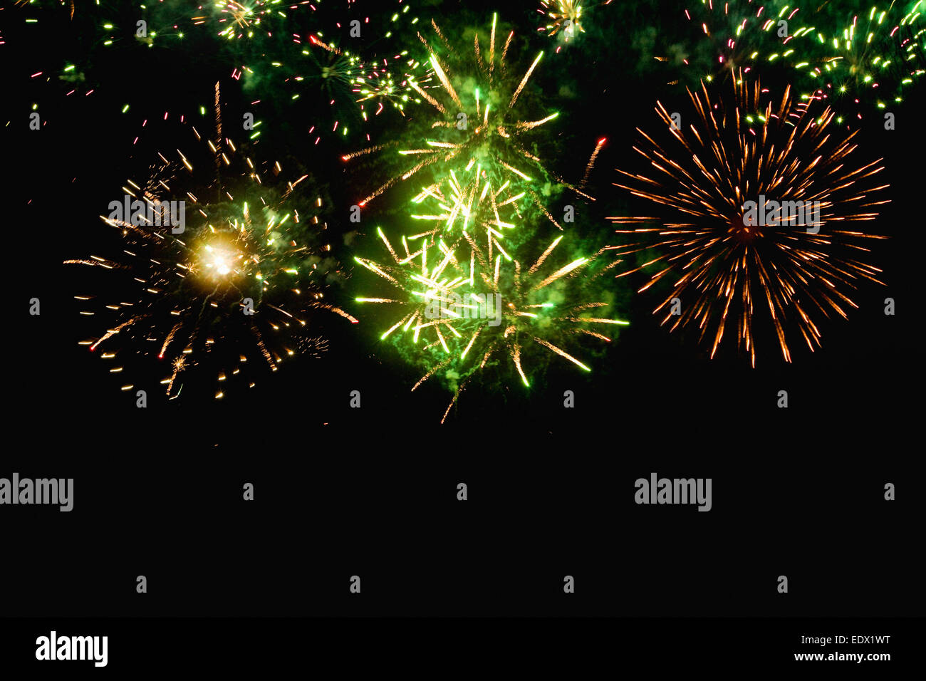 Fireworks exploding green in night sky Stock Photo - Alamy