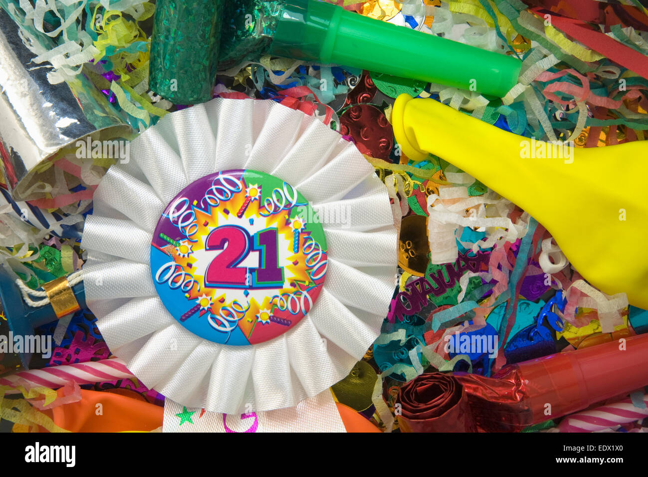 Close up shot of a 21st Birthday Ribbon Rosette surrounded by party ...
