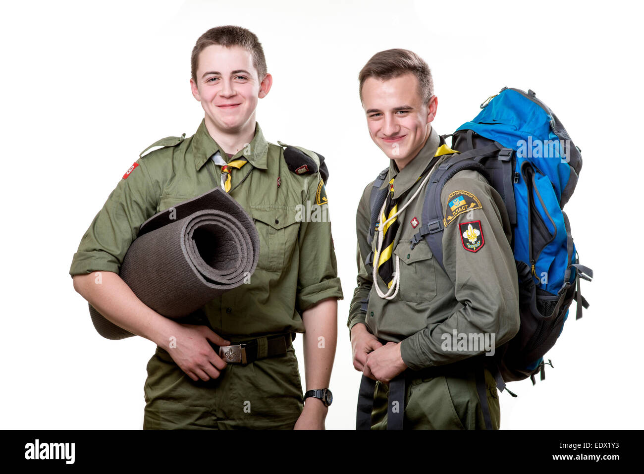 Two young scout boys with sleeping bag and backpack isolated on white ...