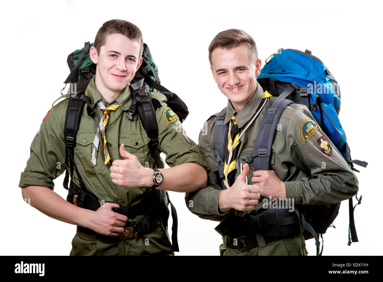 Two young scout boys with sleeping bag and backpack isolated on white ...