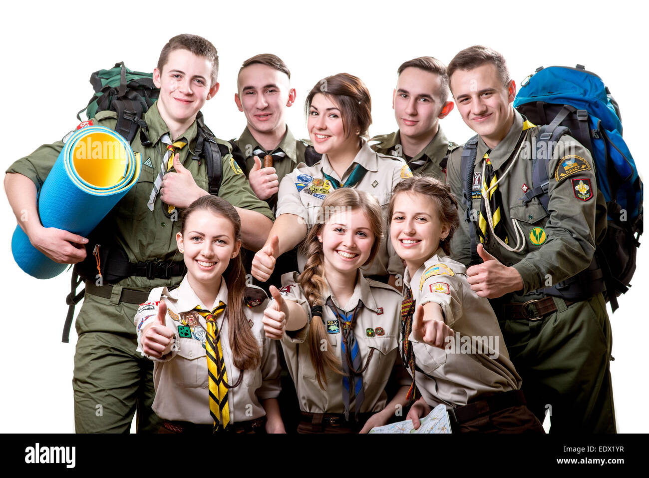 Friendly young scouts in uniform embracing together isolated on white ...