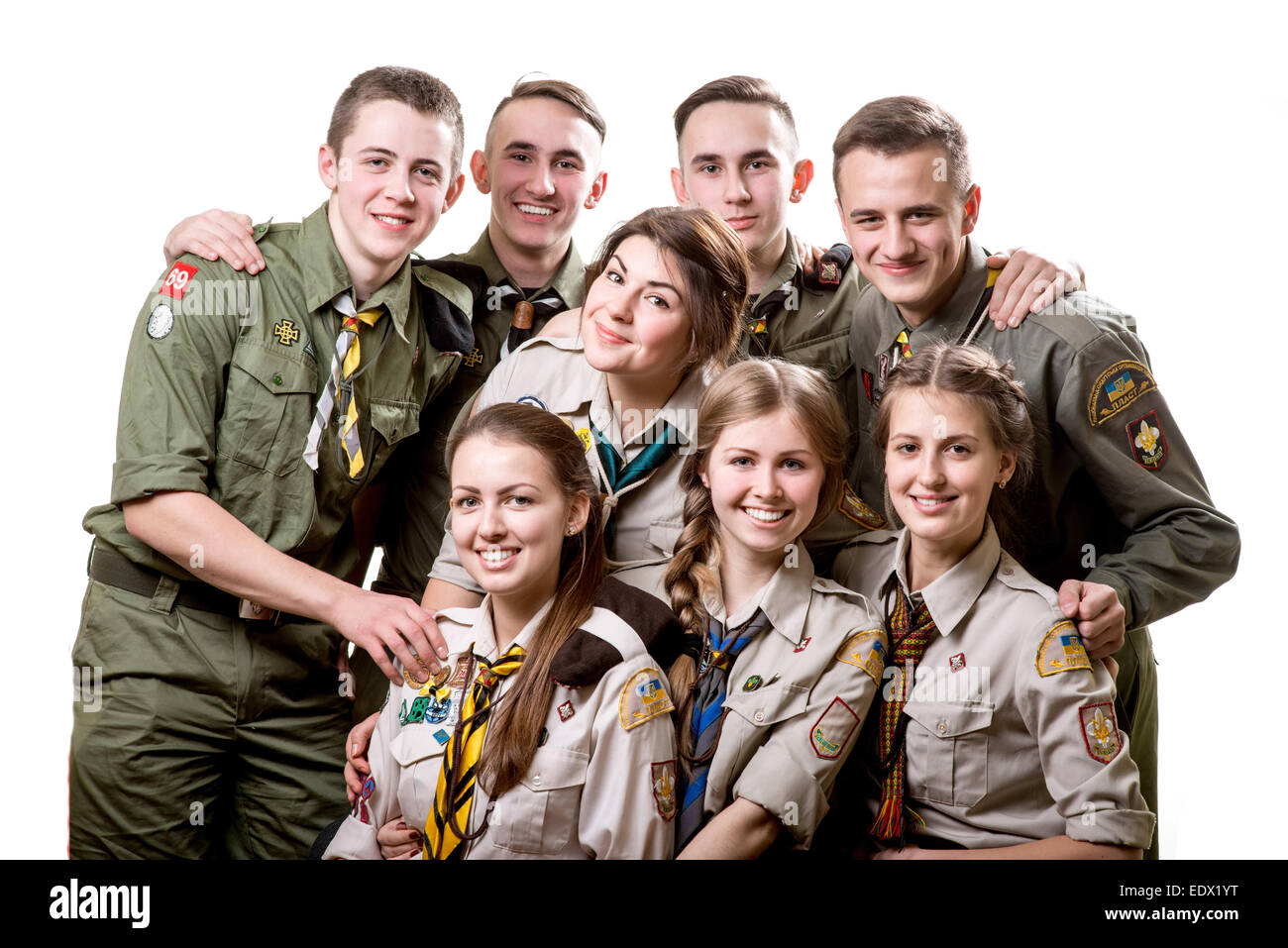 Friendly young scouts in uniform embracing together isolated on white ...