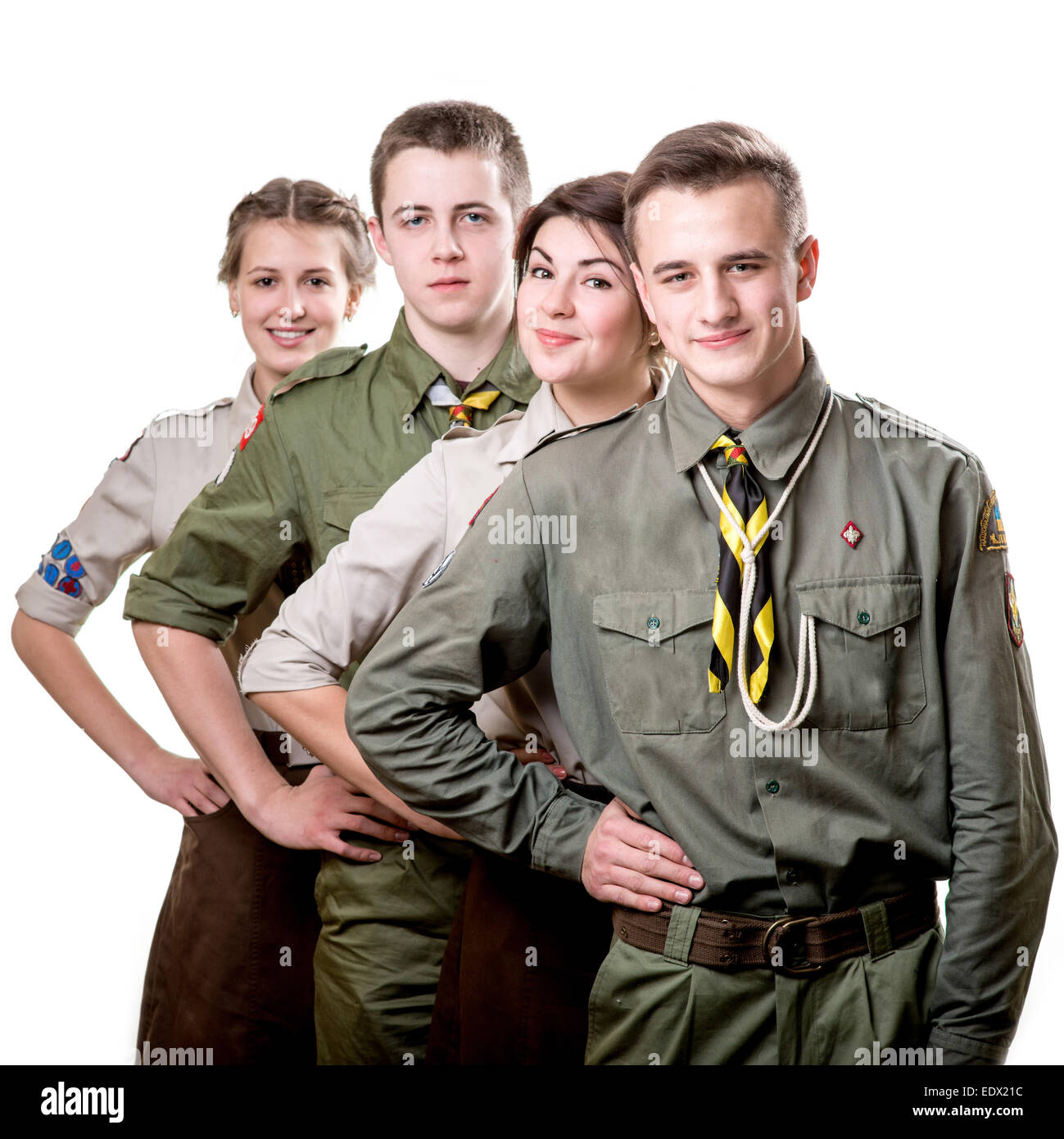 Four young scouts members in uniform on white background Stock Photo ...