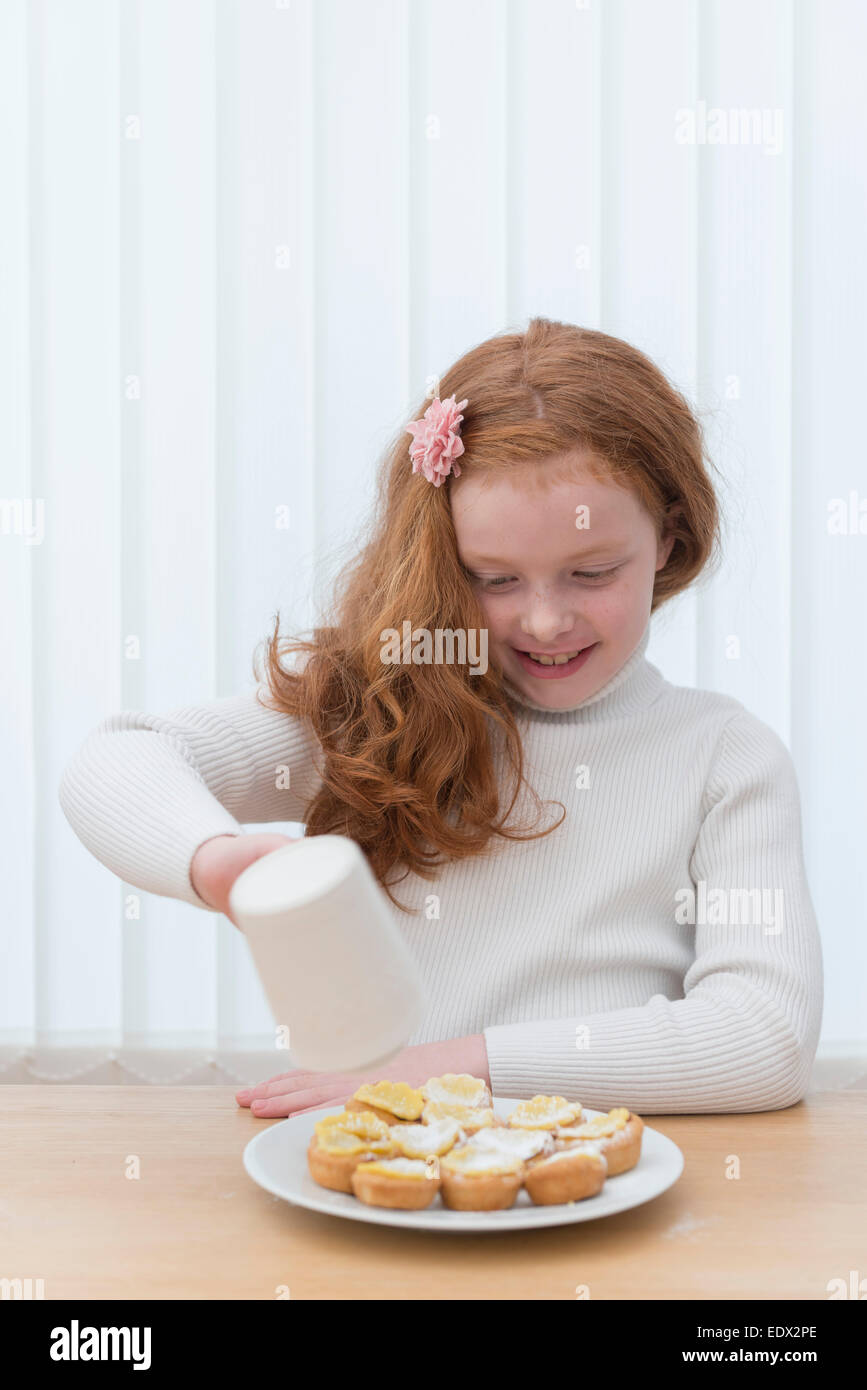 Little girl making marzipan covered mine pies Stock Photo - Alamy