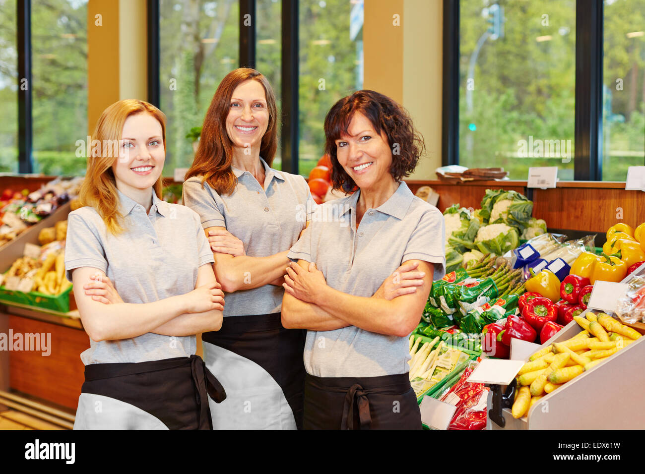 Group of three happy sales women in a supermarket Stock Photo - Alamy