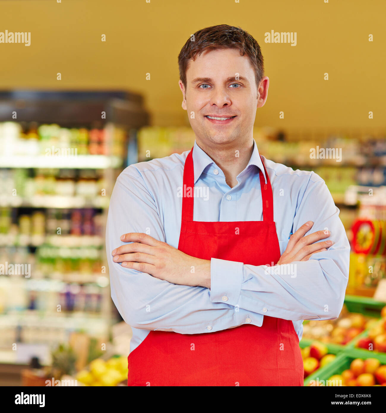 Portrait of happy retail salesman in a supermarket Stock Photo - Alamy