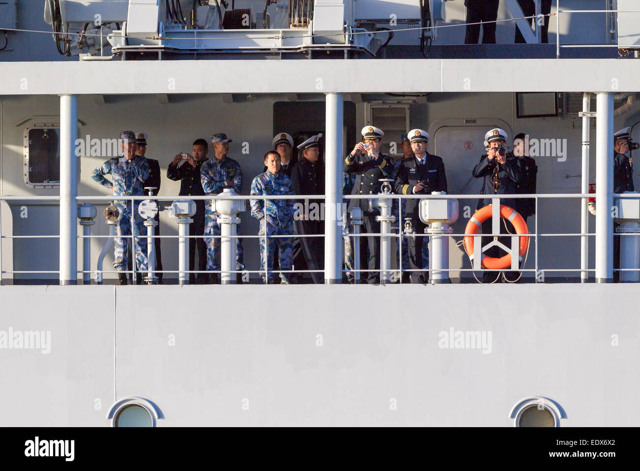 Officers aboard the Chinese Naval replenishment ship Chaohu take photos ...