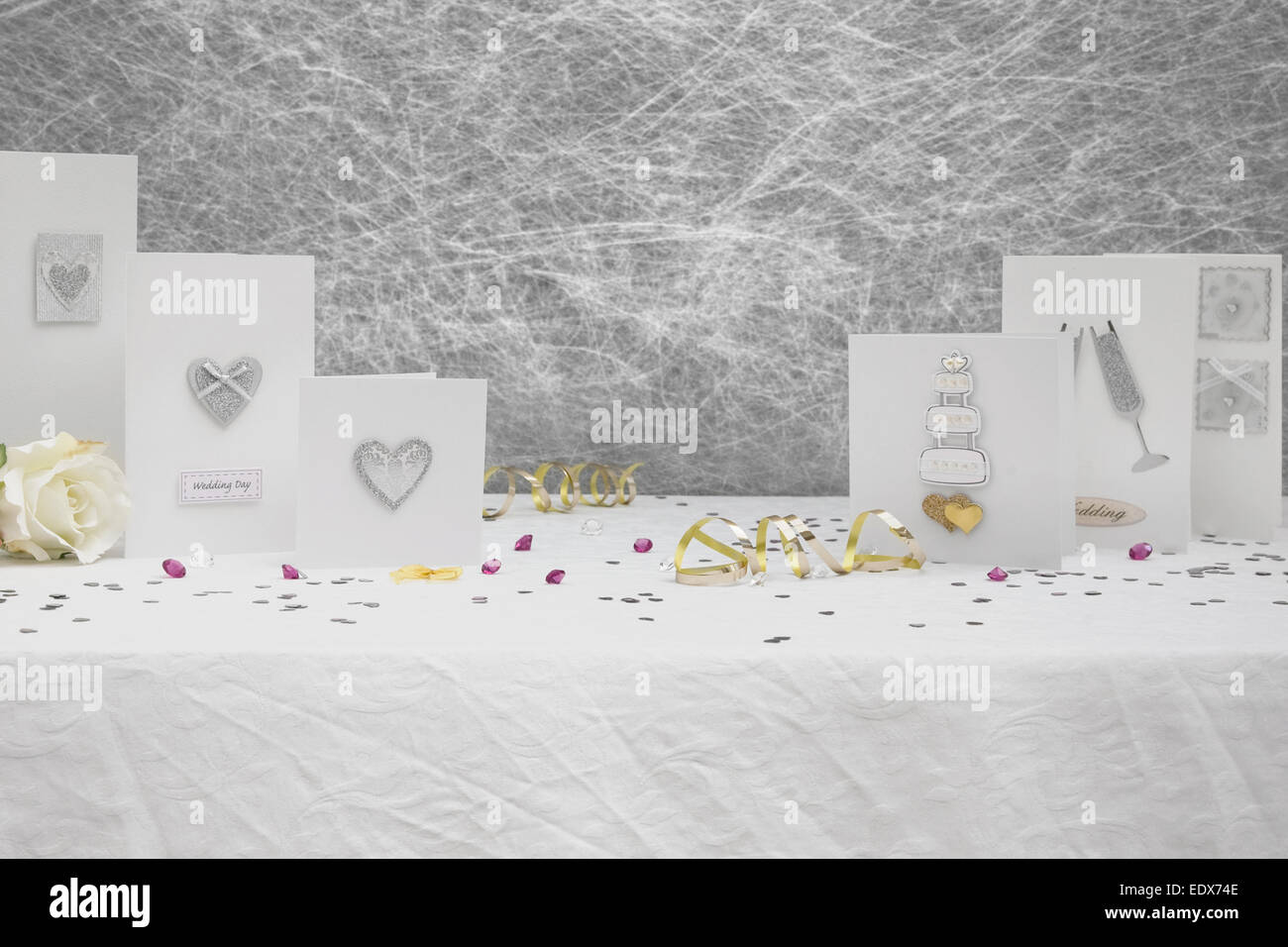 Wedding congratulation cards on a White tablecloth with gold ribbons ...
