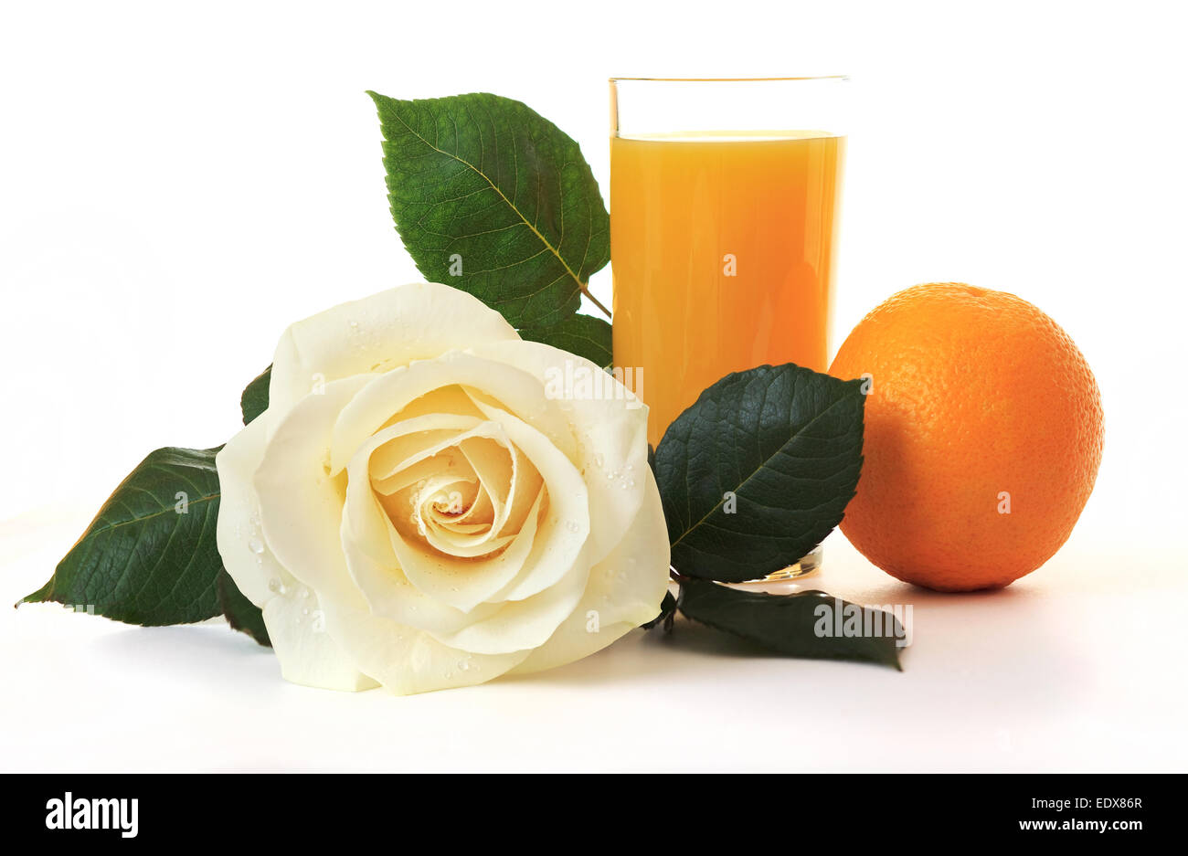 White Rose, glass of juice and orange. Still Life Stock Photo - Alamy