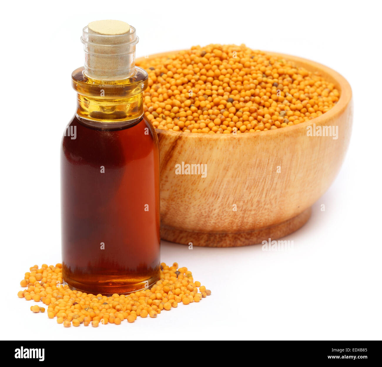 Mustard oil with grain over white background Stock Photo - Alamy
