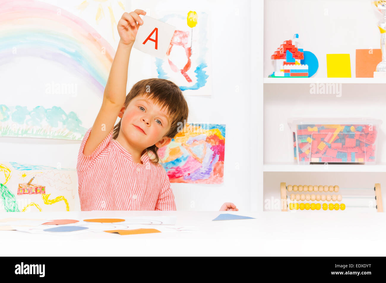 Boy learns to read showing letter card Stock Photo - Alamy
