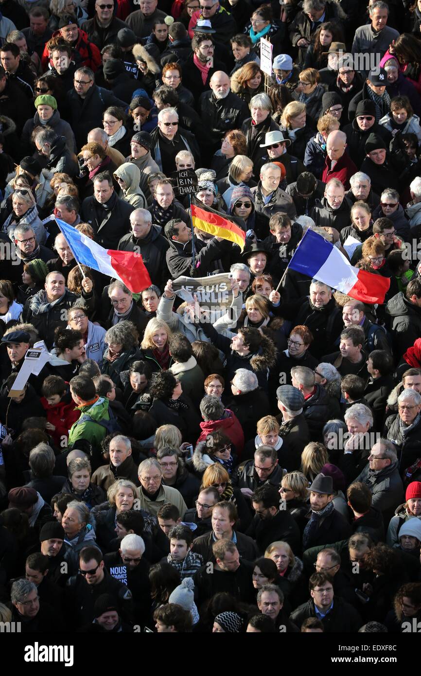 People wave French and German flags as they gather for a march against ...
