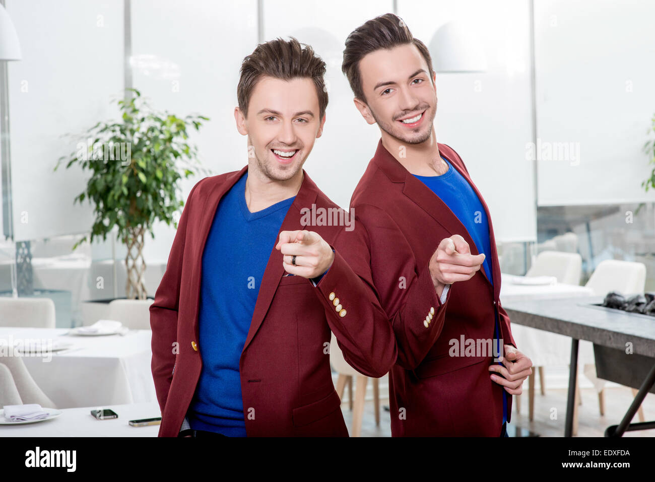 Two cheerful brothers pointing hi-res stock photography and images - Alamy