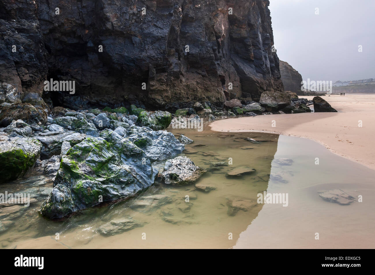Rock pool and high cliffs at Perranporth beach in Cornwall on an ...