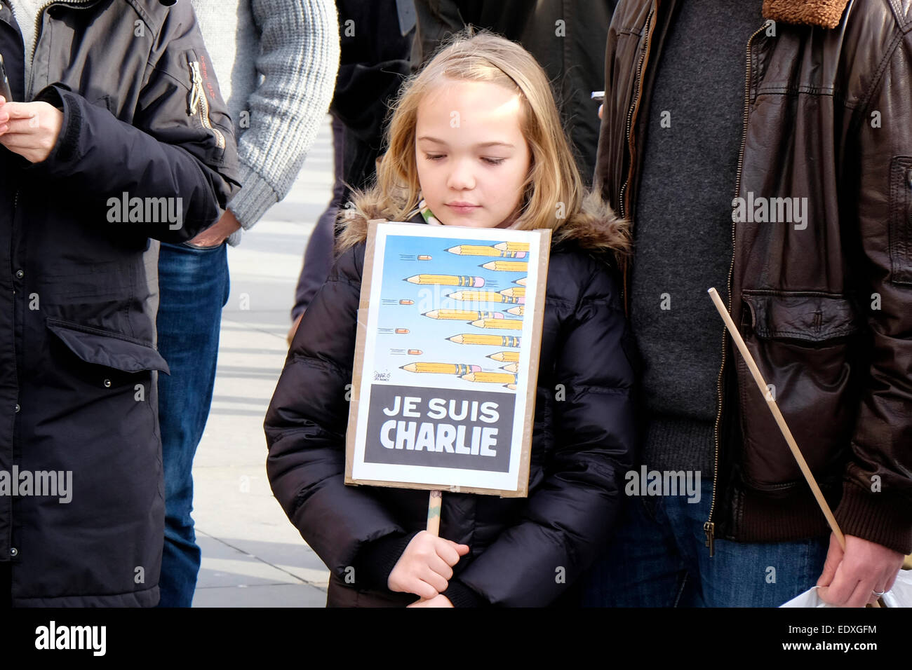A little girl holds a placard reading " Je suis Charlie", meaning, I am ...