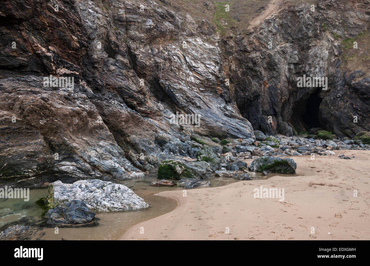 Rocky cliffs at Perranporth beach in North Cornwall. Rock pools and ...