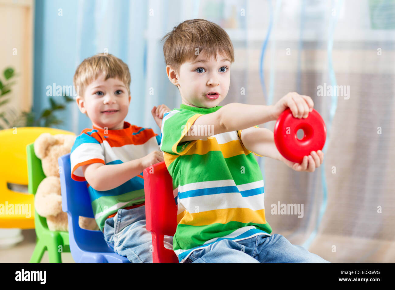 Kids riding on carriages made from chairs Stock Photo - Alamy