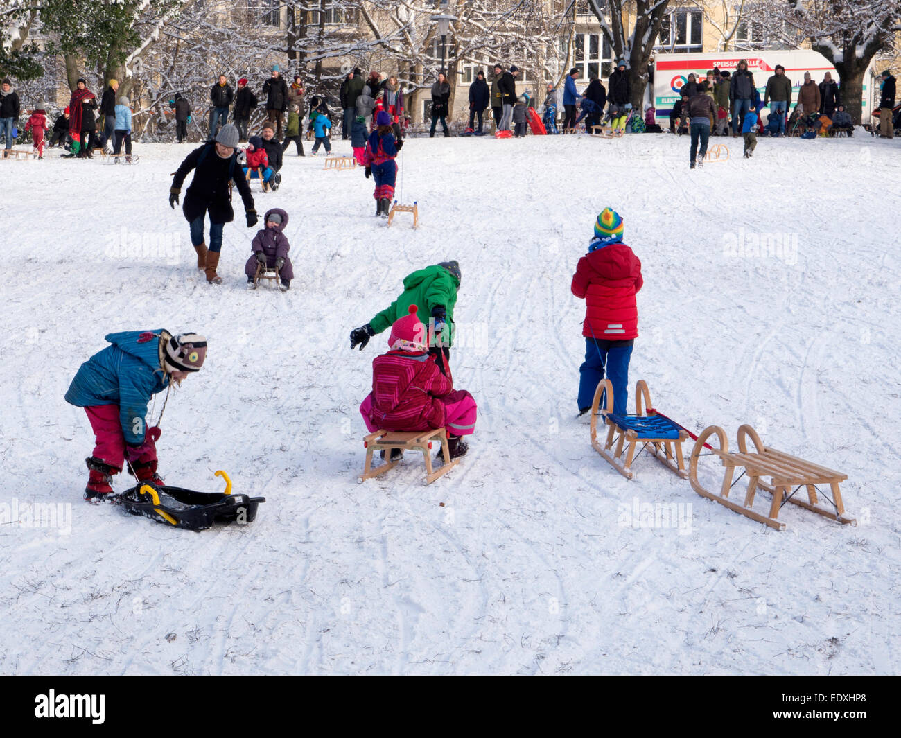 Children have fun and enjoy sledding on toboggans after winer snow in ...