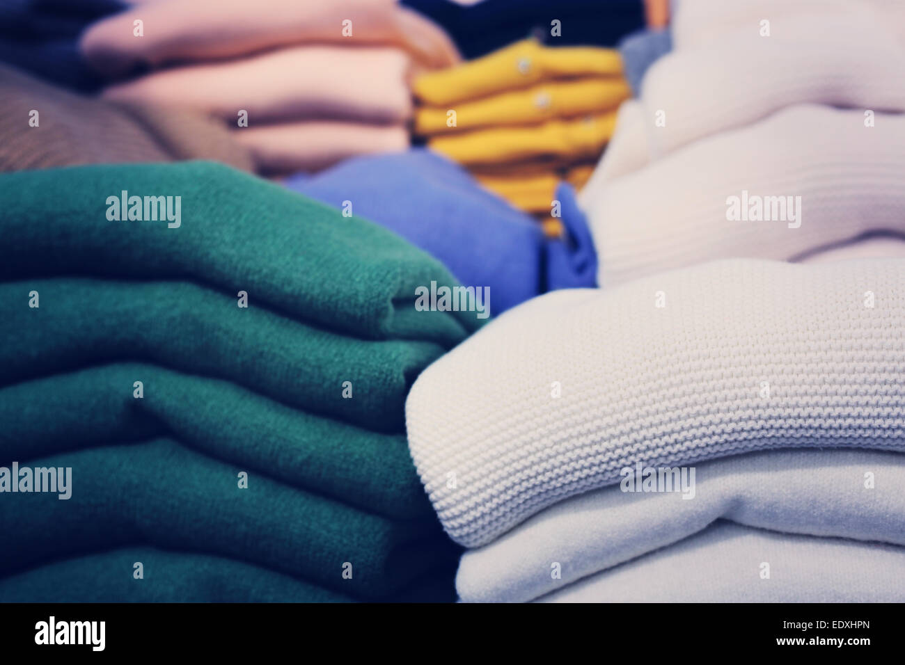 Stacks of clothes in store, close up view Stock Photo - Alamy